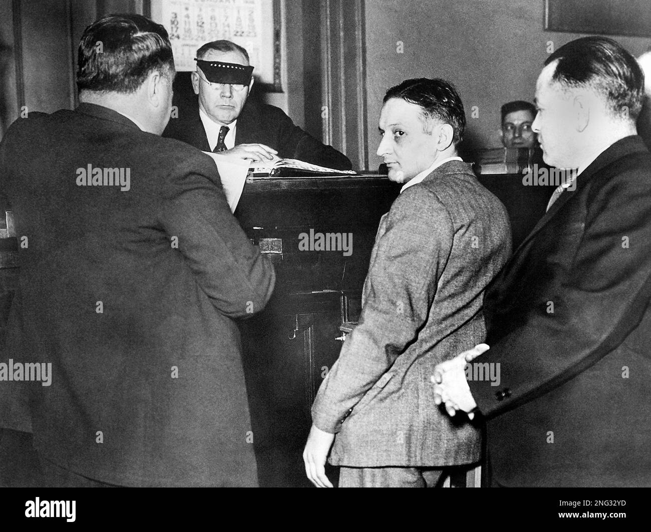 Adam Richetti, center, looking over shoulder, named by police as a ...