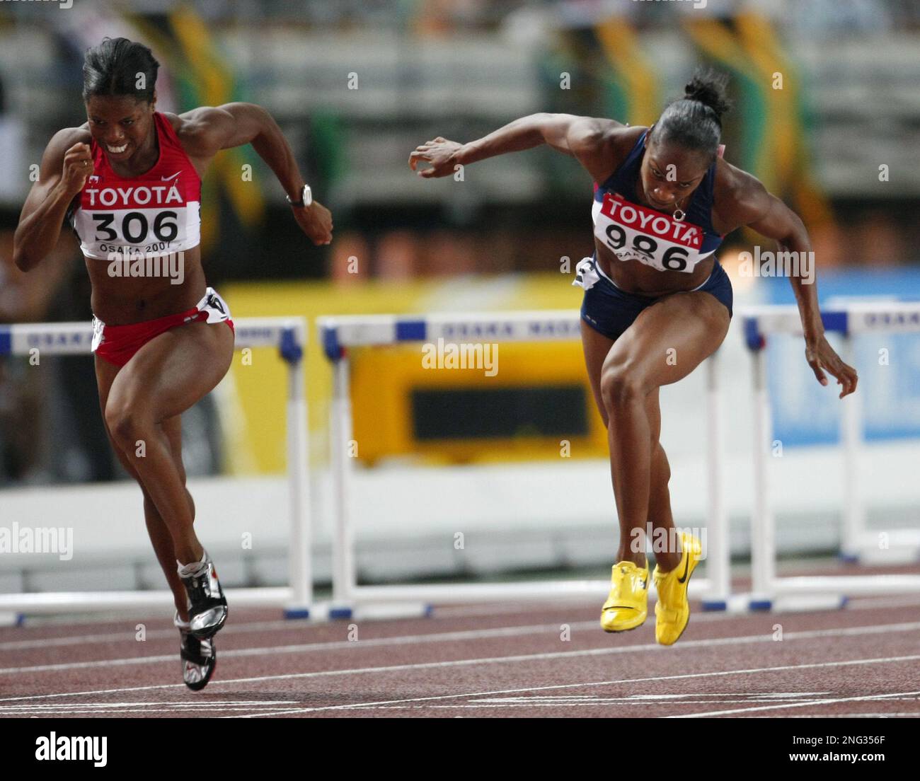 Canada's Perdita Felicien, left, and USA's Michelle Perry cross the ...