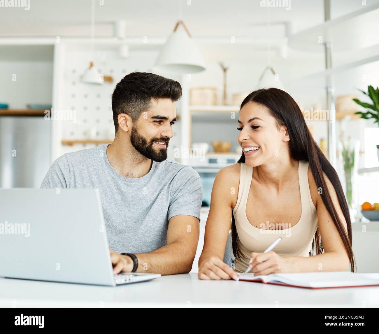 laptop woman man couple computer indoor technology young together lifestyle happy home love ...