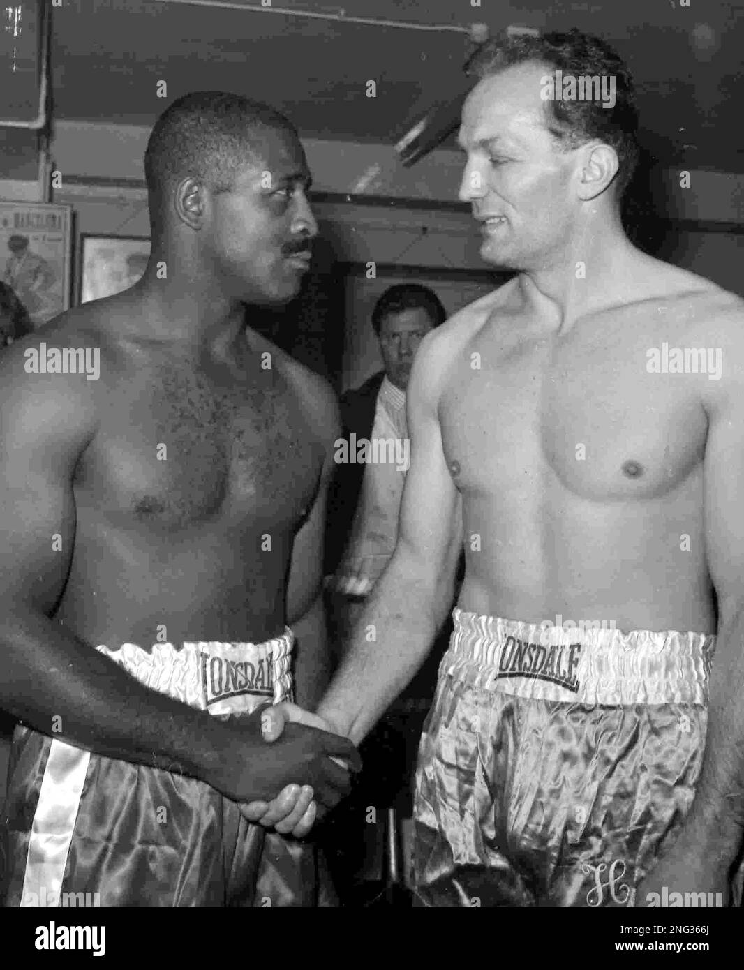British Heavyweight boxing champion Henry Cooper, right, shakes hands ...
