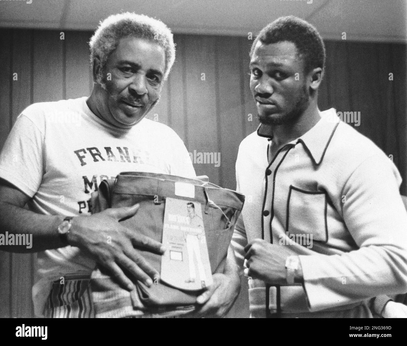Heavyweight champion Joe Frazier makes a fist as his manager Yank ...