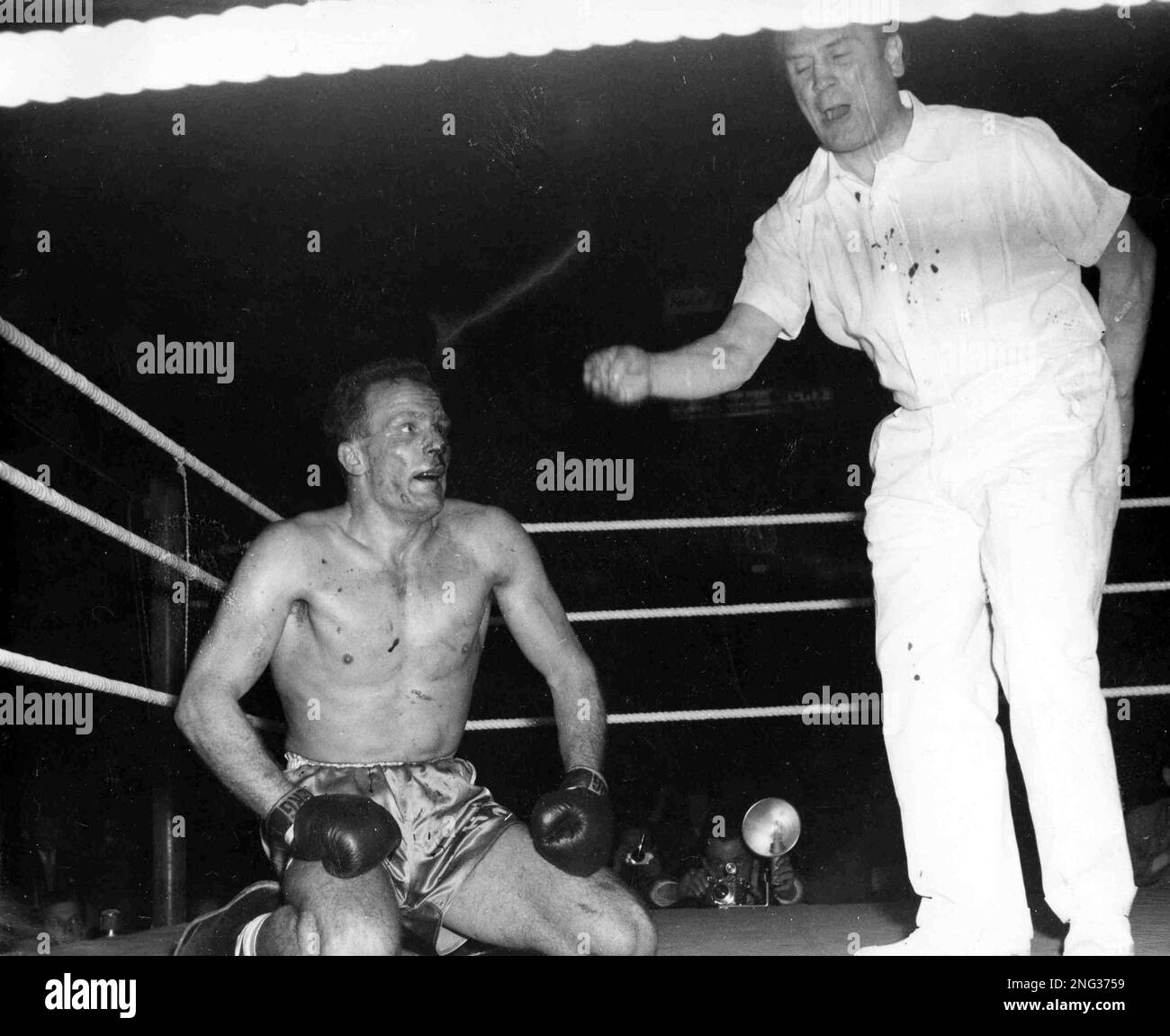 British Light Heavyweight boxer Henry Cooper kneels on the canvas as ...