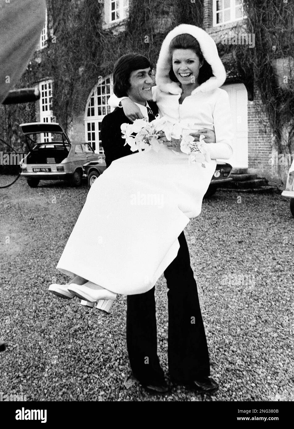 Romanian tennis star Ile Nastase carries former French model Dominique ...