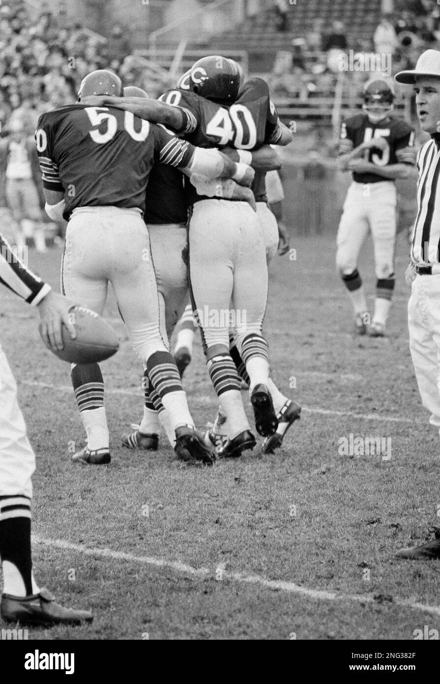 Chicago Bears teammates help Gale Sayers off the field after he was ...