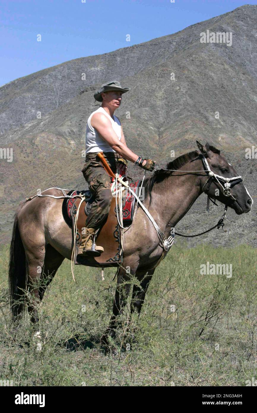 Russian President Vladimir Putin riding horseback during a trip in the ...
