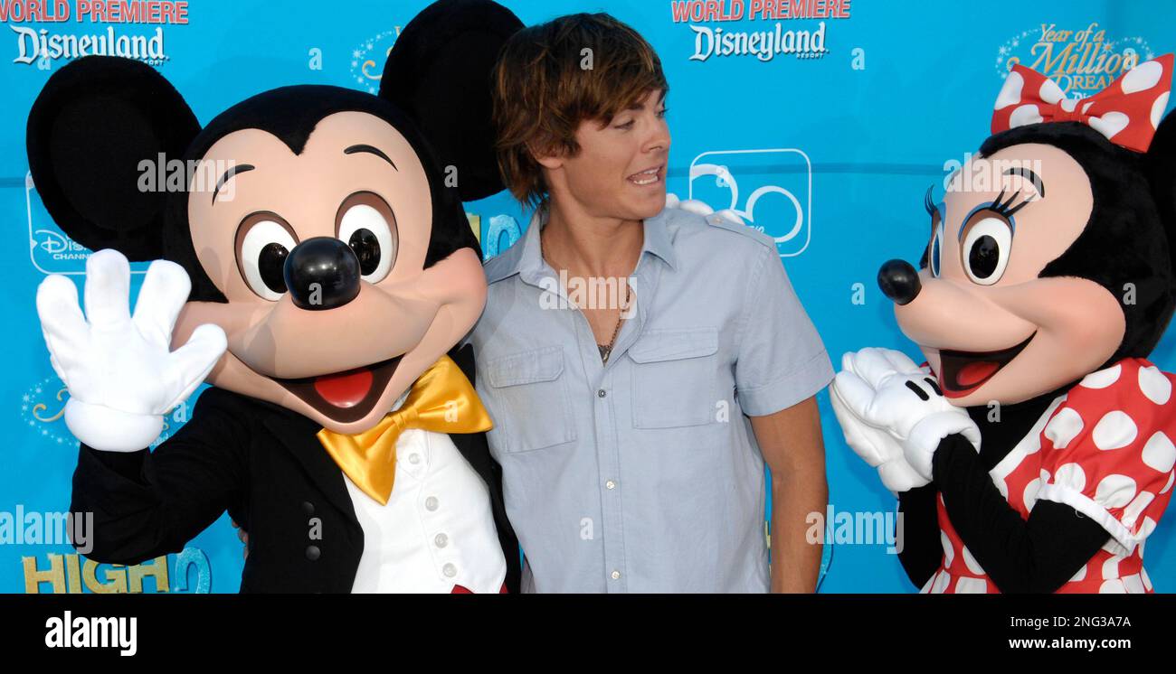 Zac Efron, center, character Mickey Mouse, right, and character Minnie ...