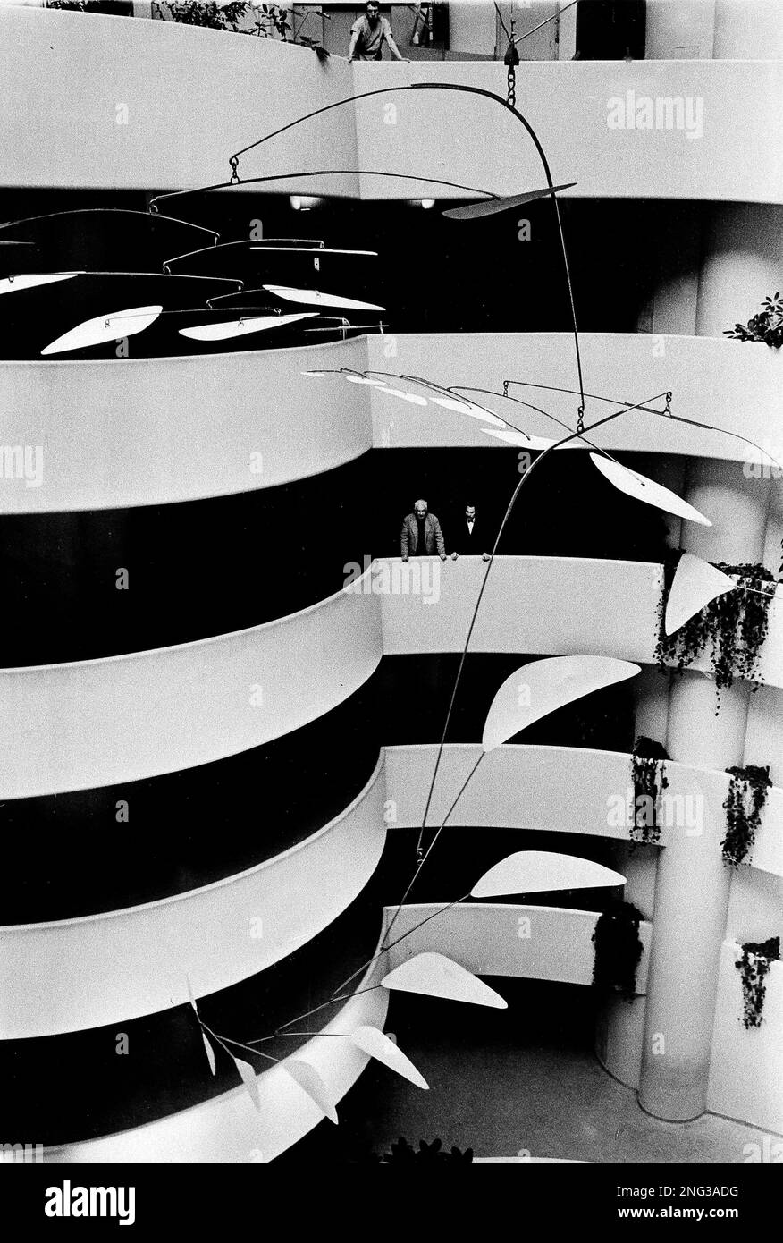 The 35-foot mobile "The Ghost" is studied by artist Alexander Calder ...