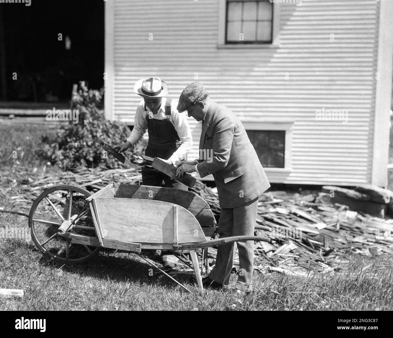 President Calvin Coolidge and his son, John, work on the shingles pile ...