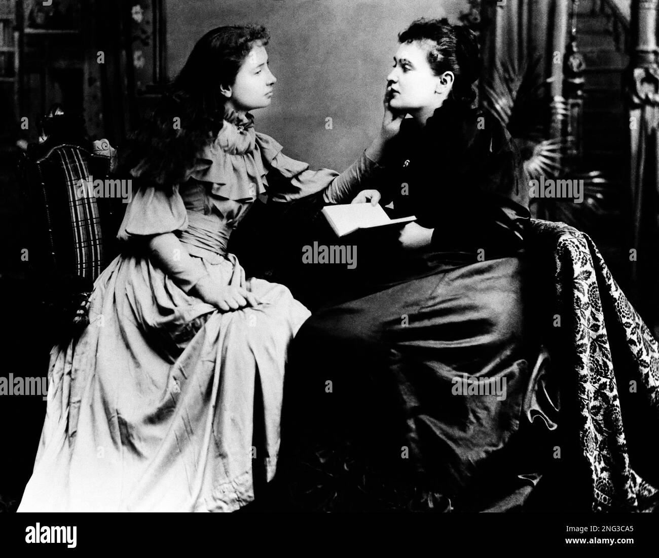 Helen Keller (left) "hears" Anne Sullivan by feeling the vibrations on ...