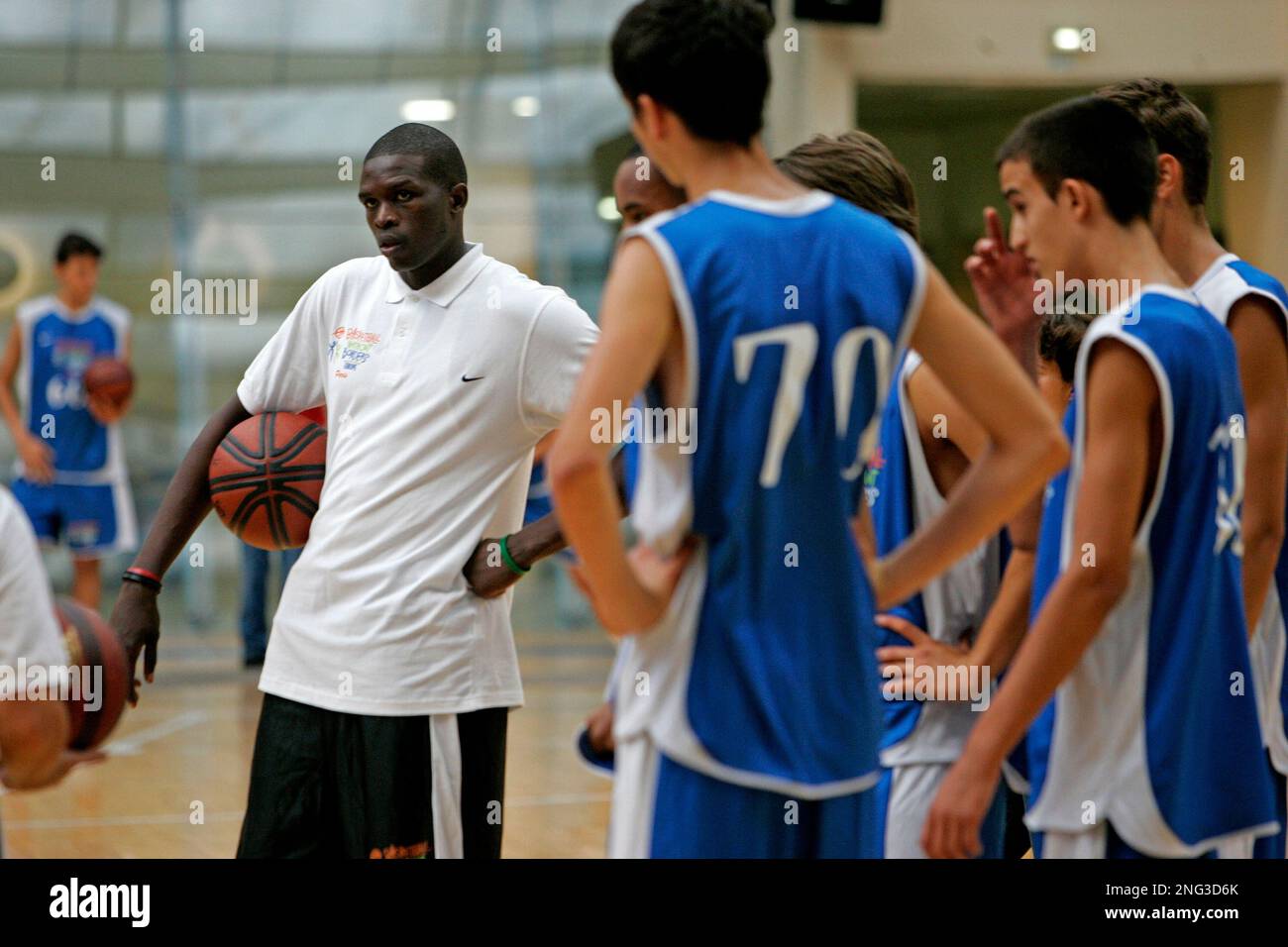 NBA player Luol Deng of the Chicago Bulls, left, shows some tips to ...