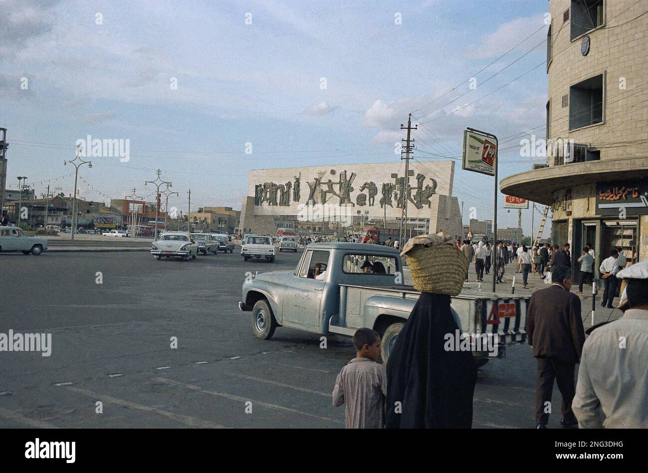 Women shrouded in black cross street against backdrop of imposing ...