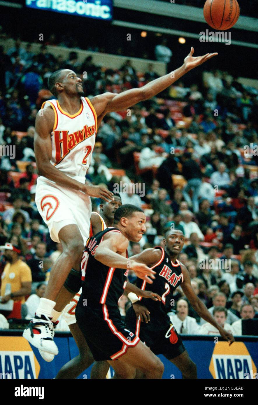 Atlanta Hawks' Stacey Augmon, left, goes over the back of Miami Heat's ...