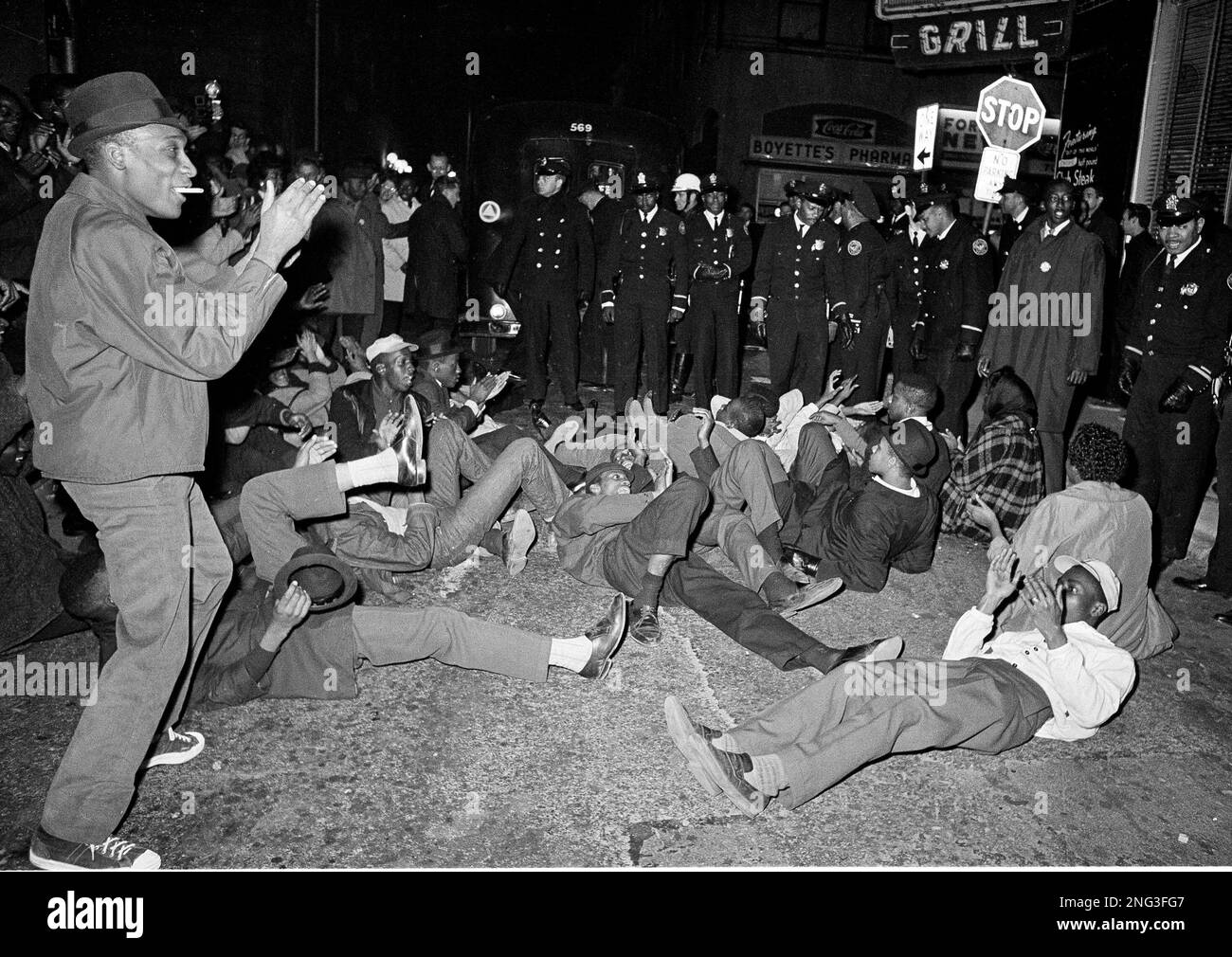 Blacks protesting a segregated restaurant lie in the street a block ...