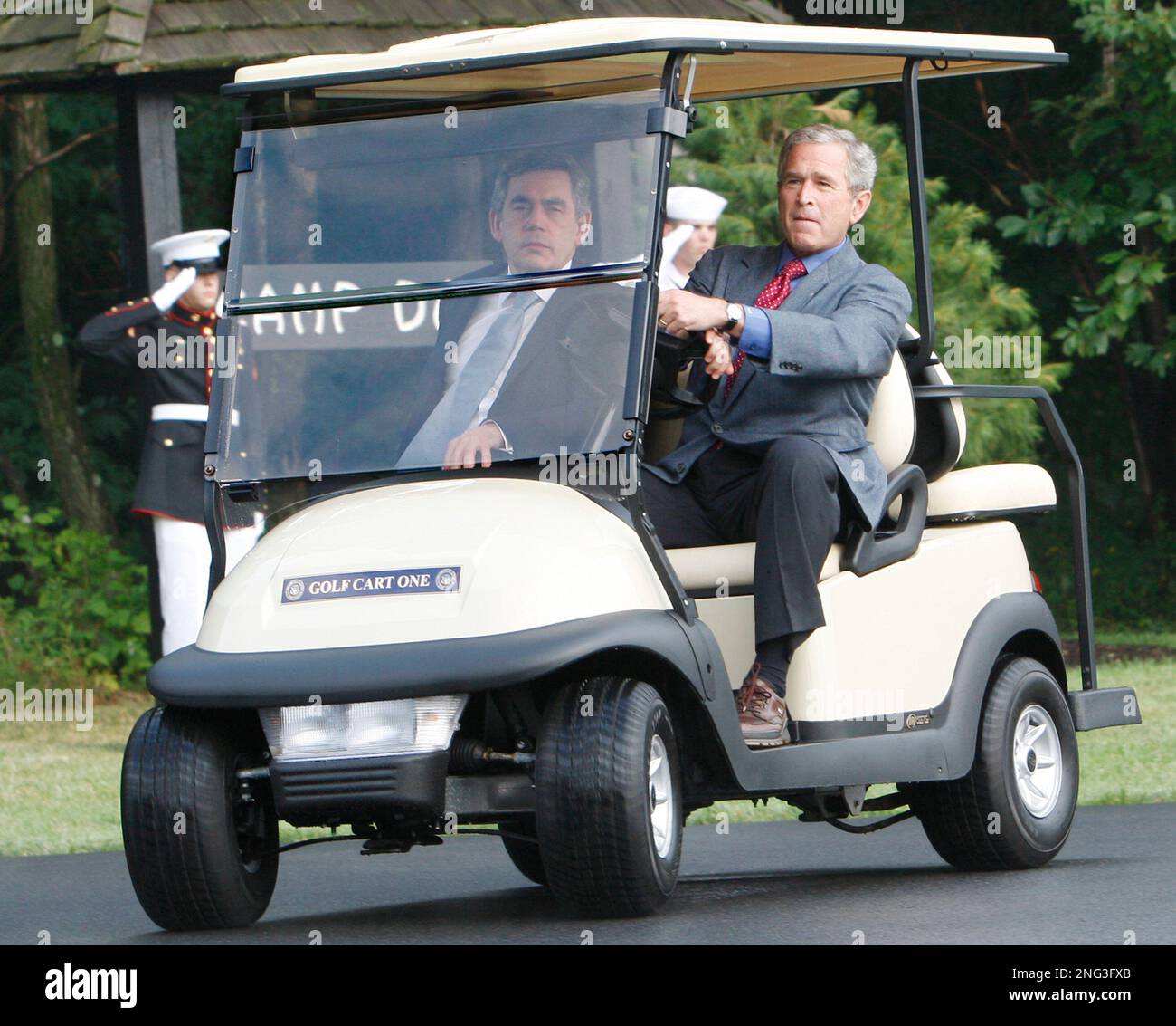 President Bush drives British Prime Minister Gordon Brown in a golf ...