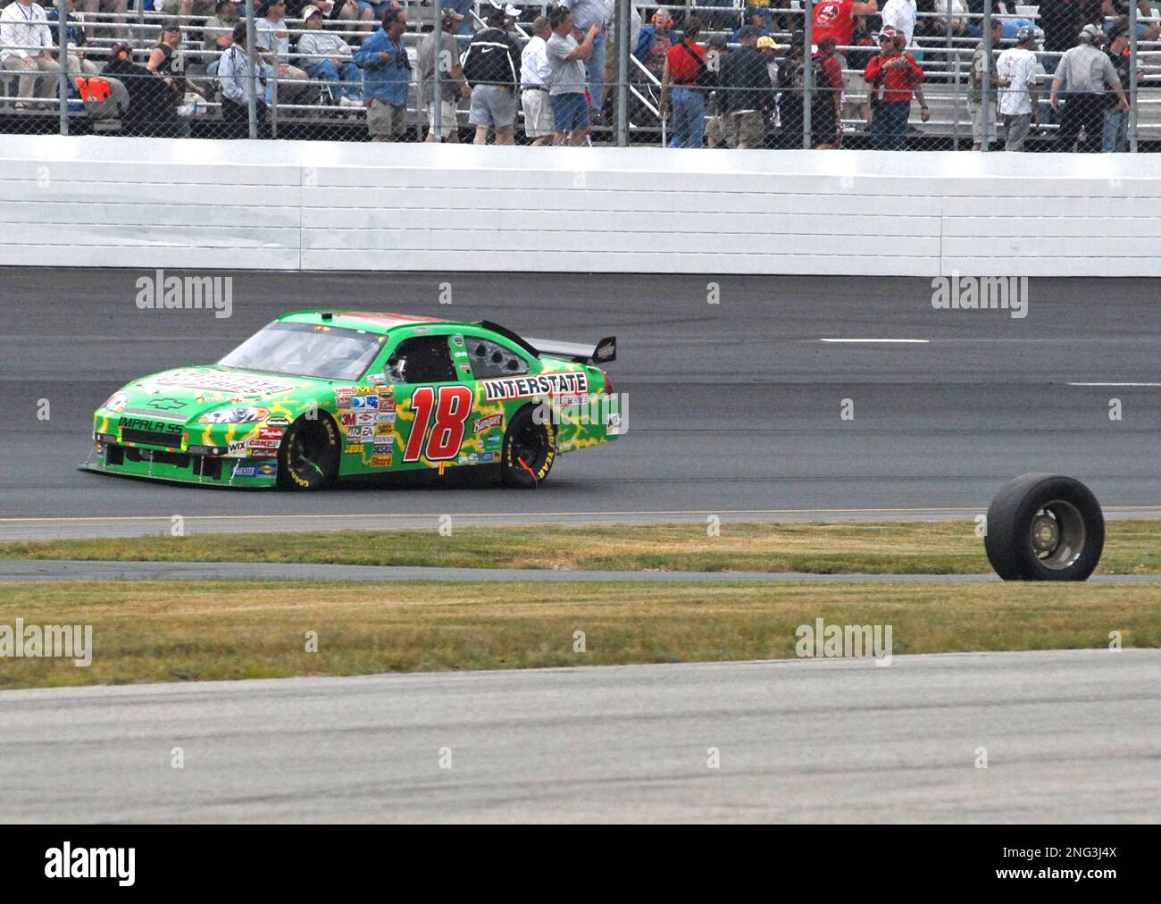 NASCAR driver J.J. Yeley (18) races past another car's tire during the ...