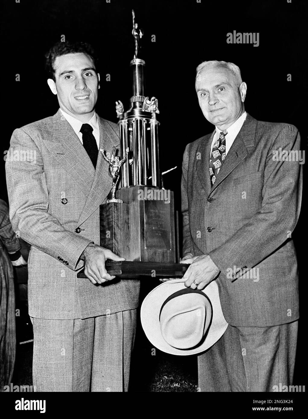 Charley Trippi, right, of the University of Georgia, receives a trophy ...
