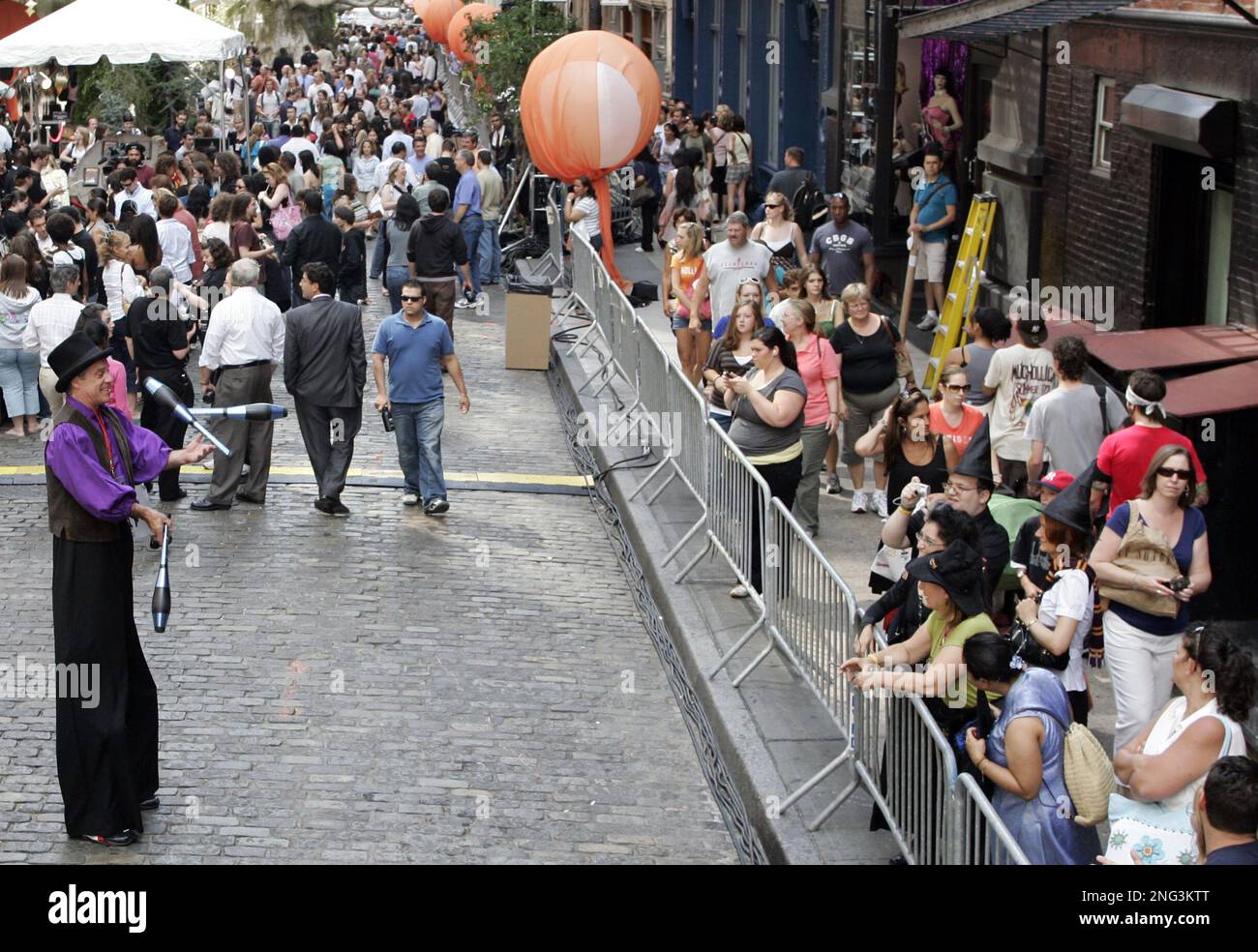 A juggler performs on a closed street for fans at the Harry Potter and ...
