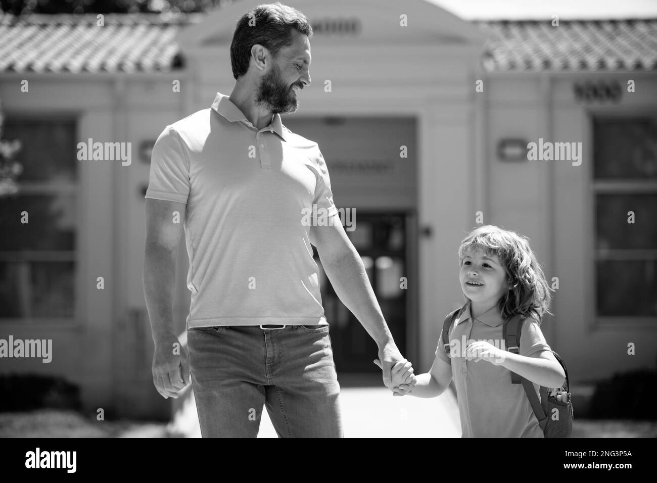 Father walking son to school. Parent and pupil of primary school ...