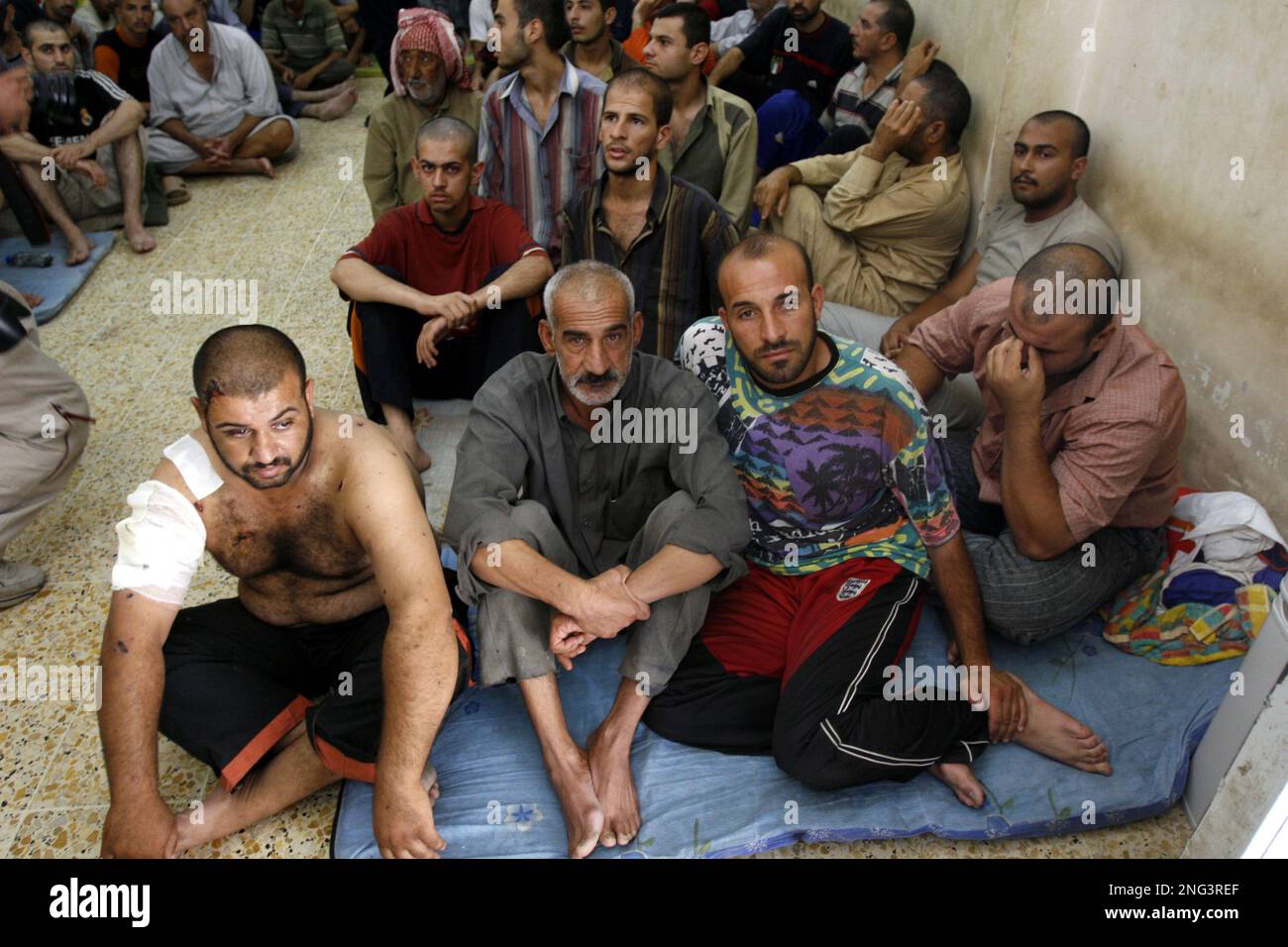 Iraqi prisoners are seen during a tour of a detention center in the ...