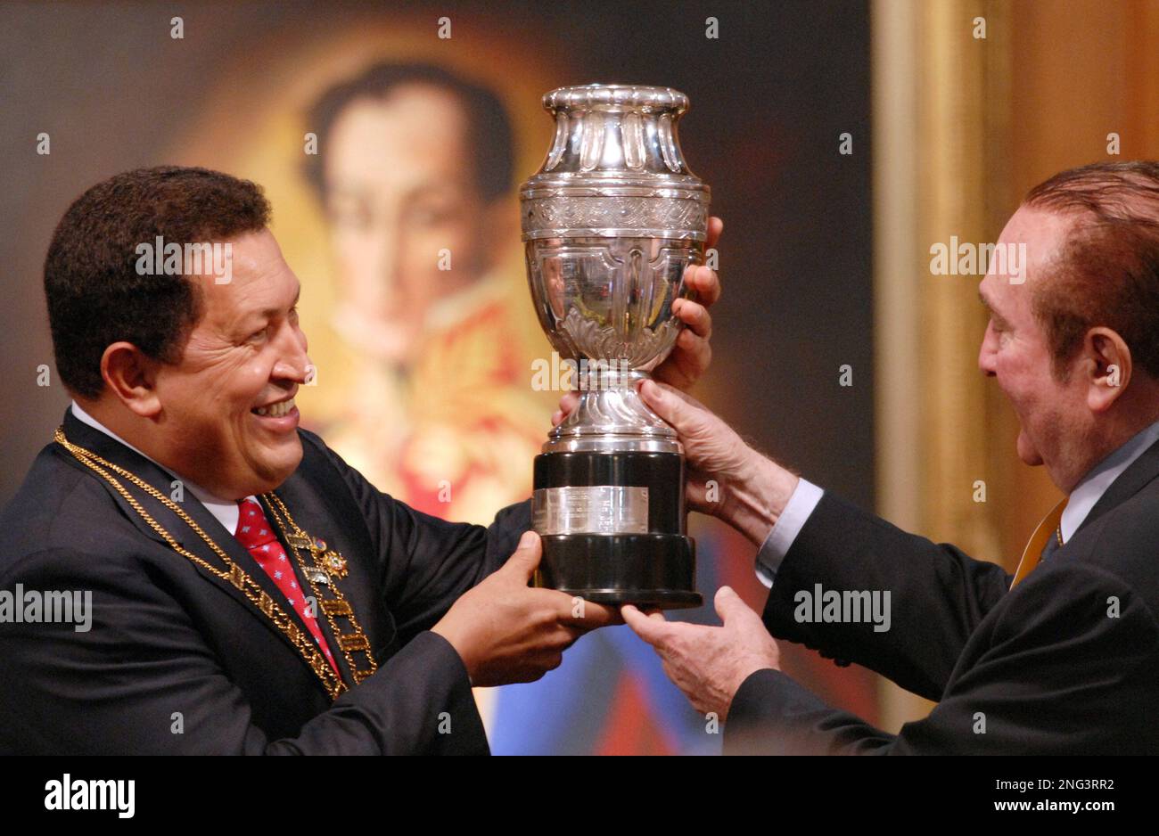 Venezuela's President Hugo Chavez, left, receives a replica of the Copa ...