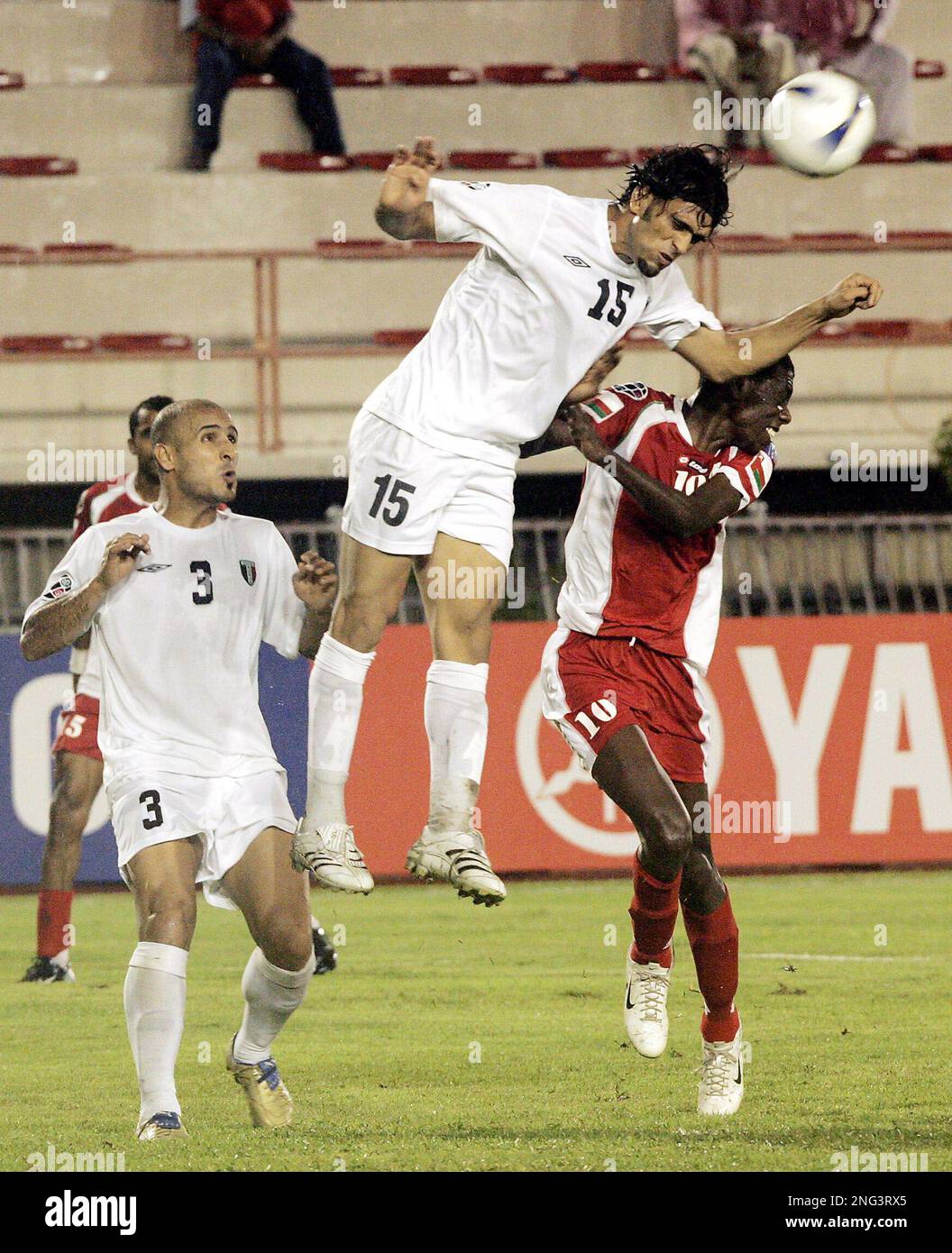 Iraq's Ali Rehema, 15, heads the ball above Oman's Fawzi Bait Doorbeen ...