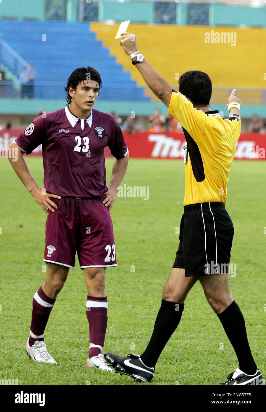 Qatar's Sebastian Quintana, left, gets a yellow card during AFC Asian ...