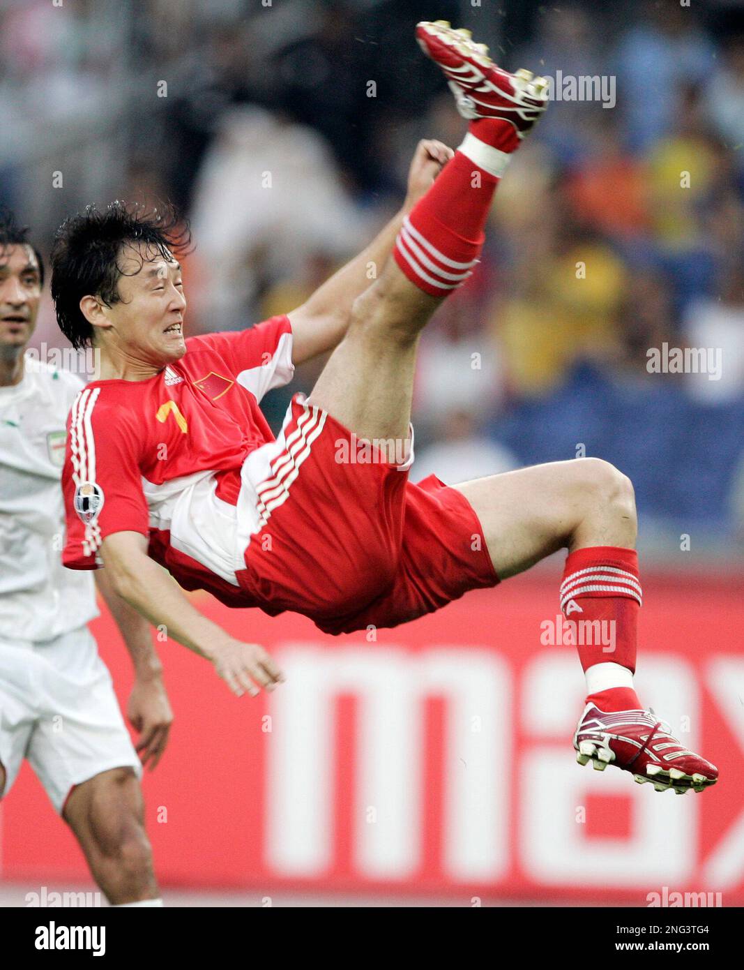 Sun Jihai, left, from China returns a kick during Asian Cup Group C ...