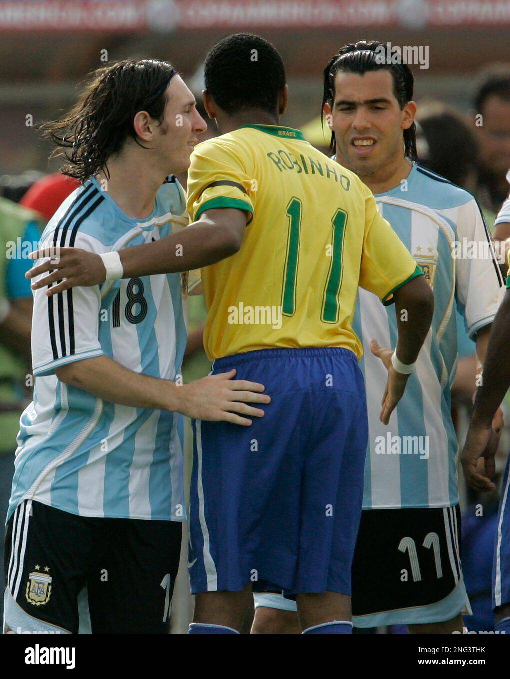 Argentina's Lionel Messi, left, and Carlos Tevez, right, greet Brazil's ...
