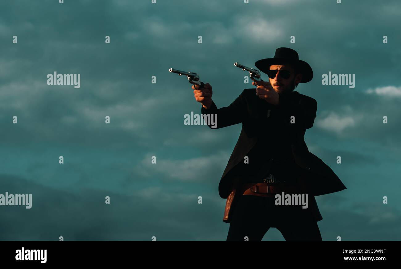 American cowboy shooting. Handsome brutal western guy. Sheriff with ...