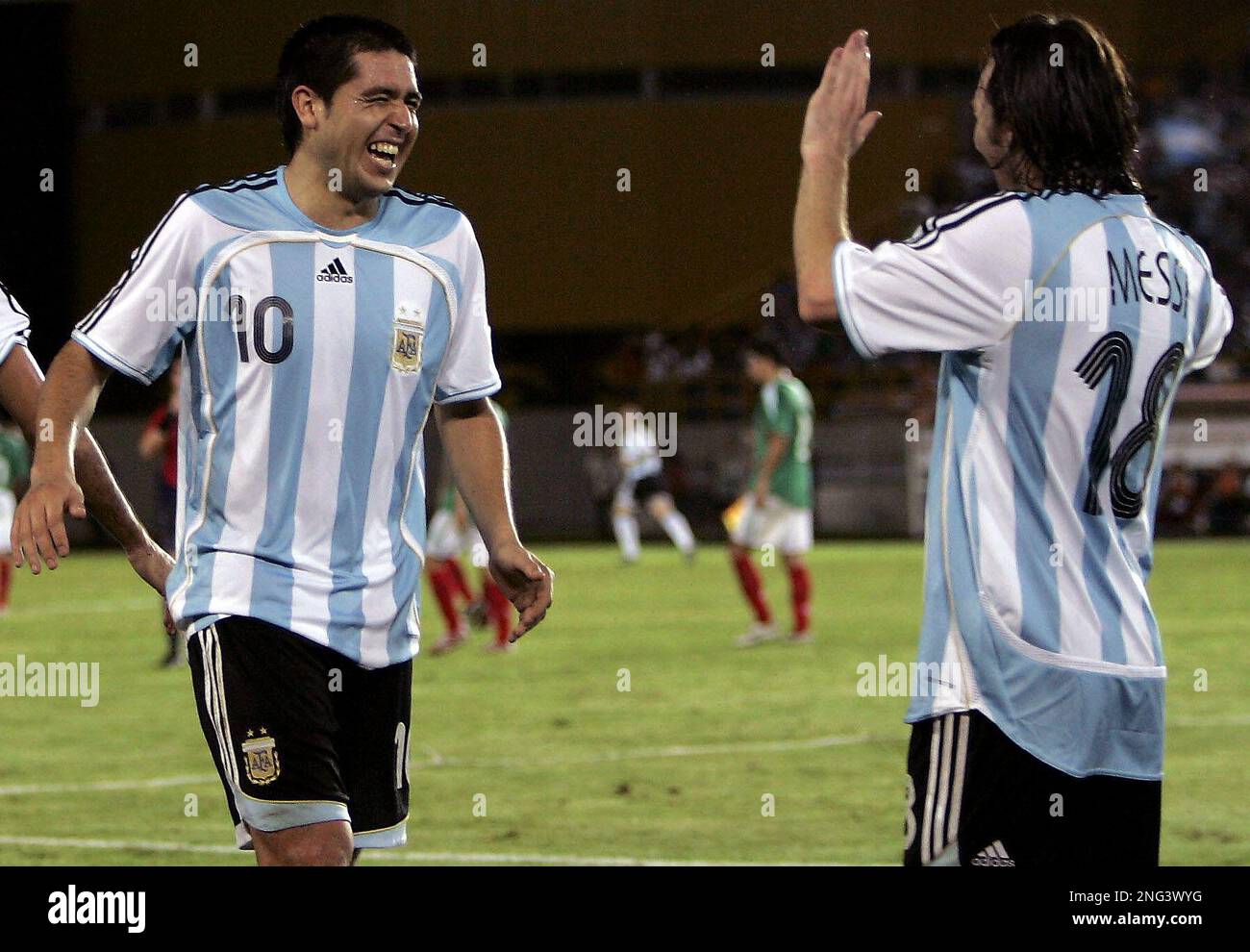 Argentina's Lionel Messi, right, celebrates with Juan Roman Riquelme ...