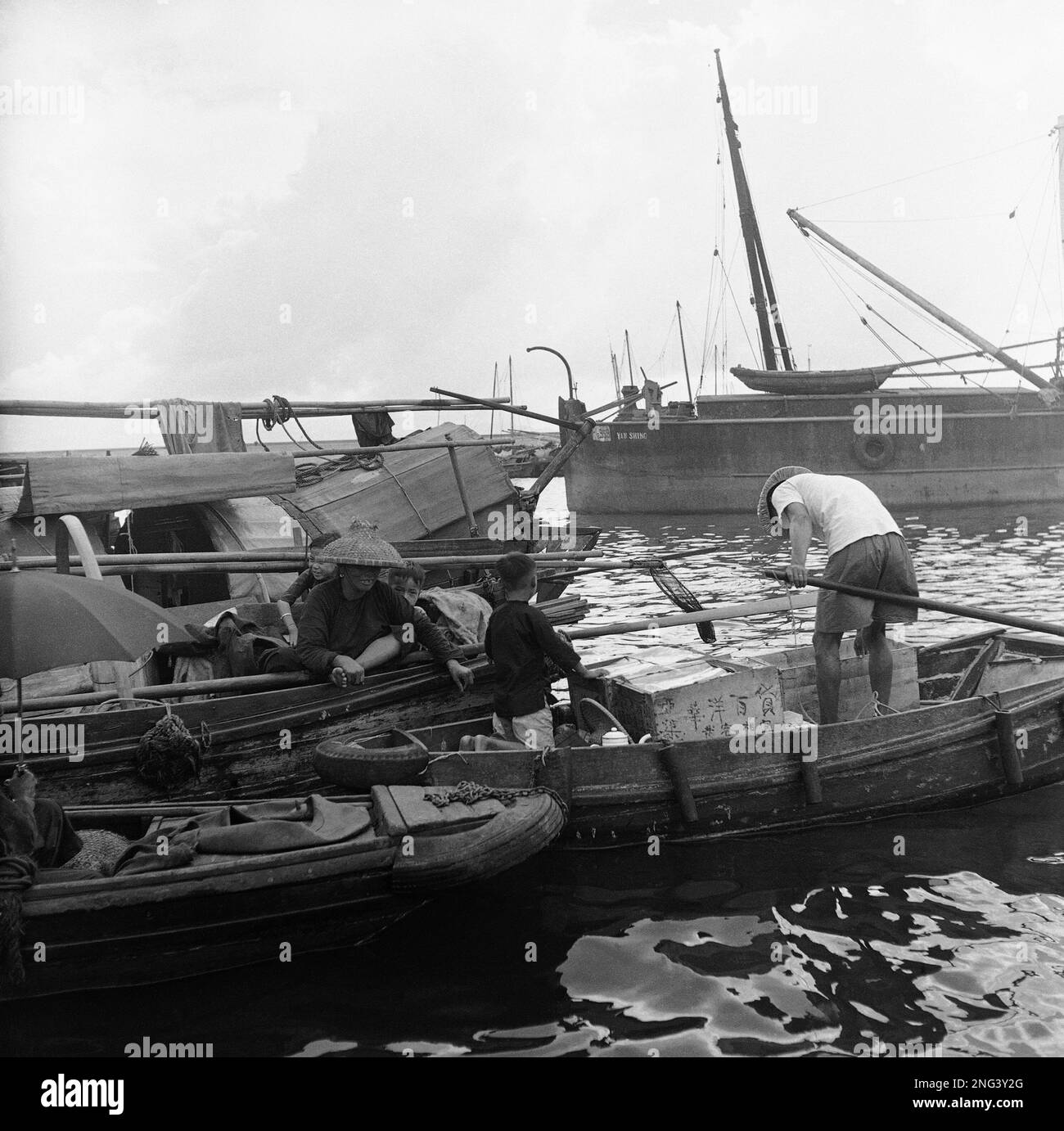 Yaumati boatman maneuver in brackish water behind the long concrete ...