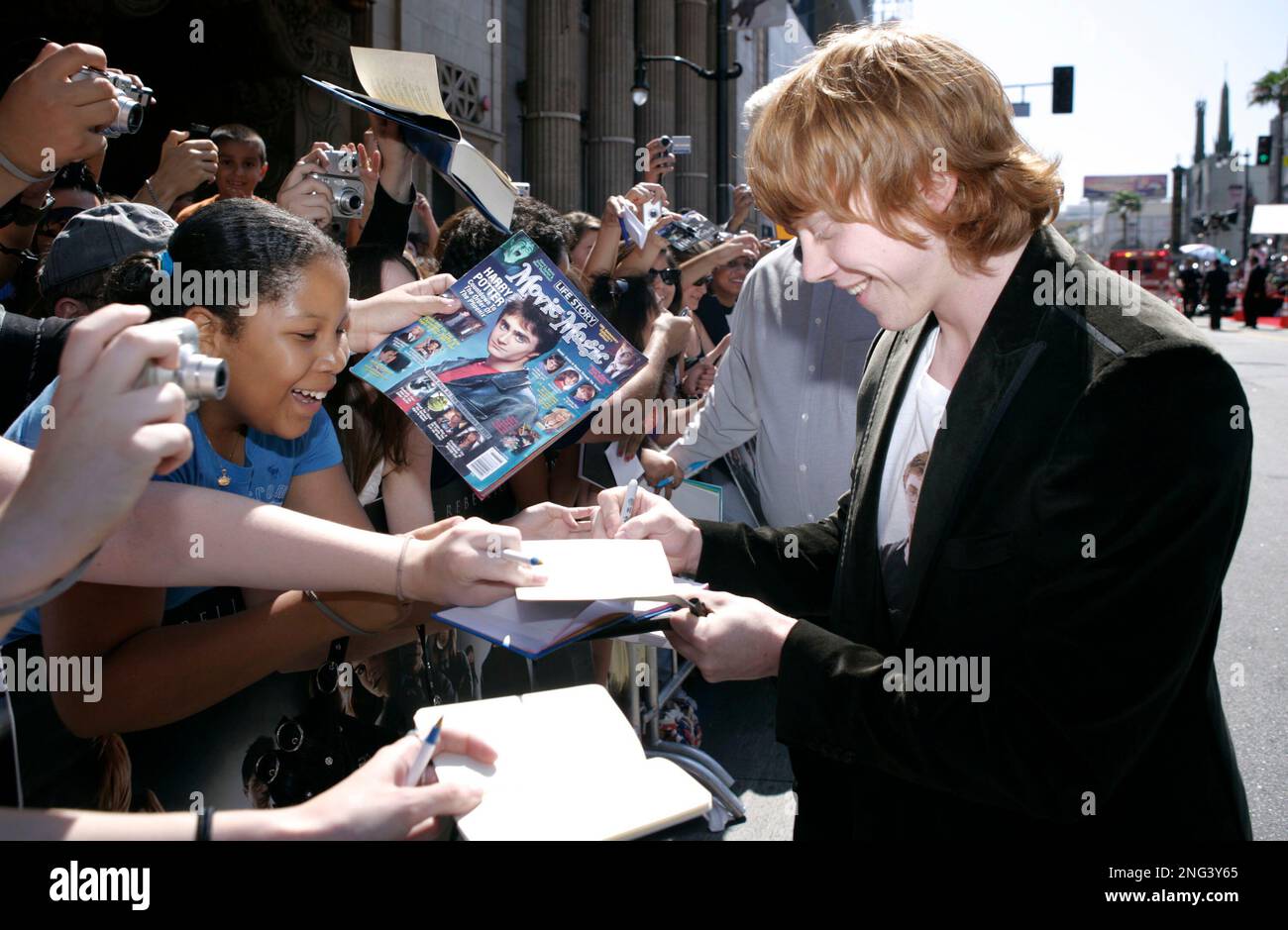 Rupert Grint signs autographs for fans at the premiere of "Harry Potter ...