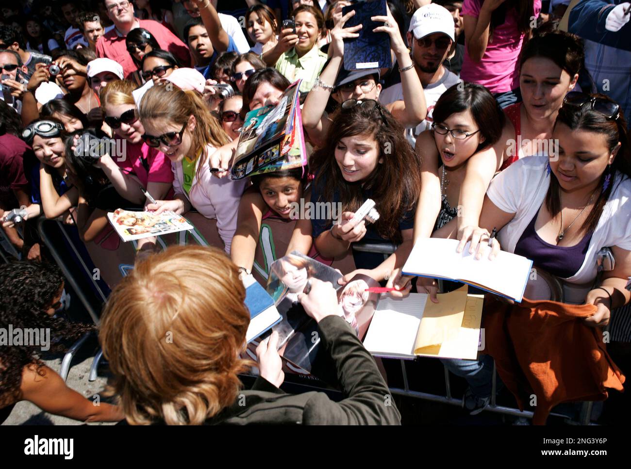 Rupert Grint signs autographs for fans at the premiere of "Harry Potter ...