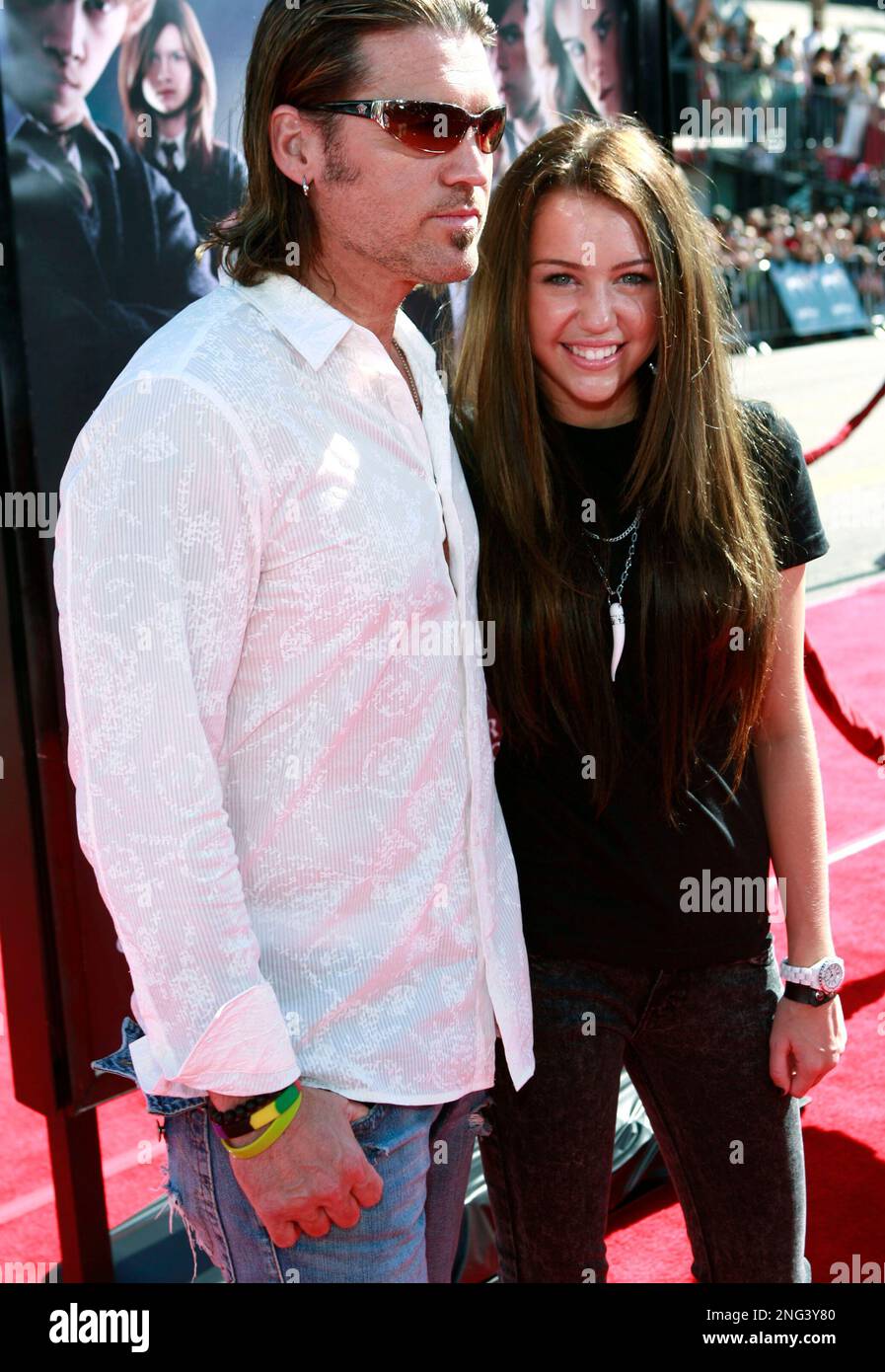 Miley Cyrus, right, and Billy Ray Cyrus arrive at the premiere of ...