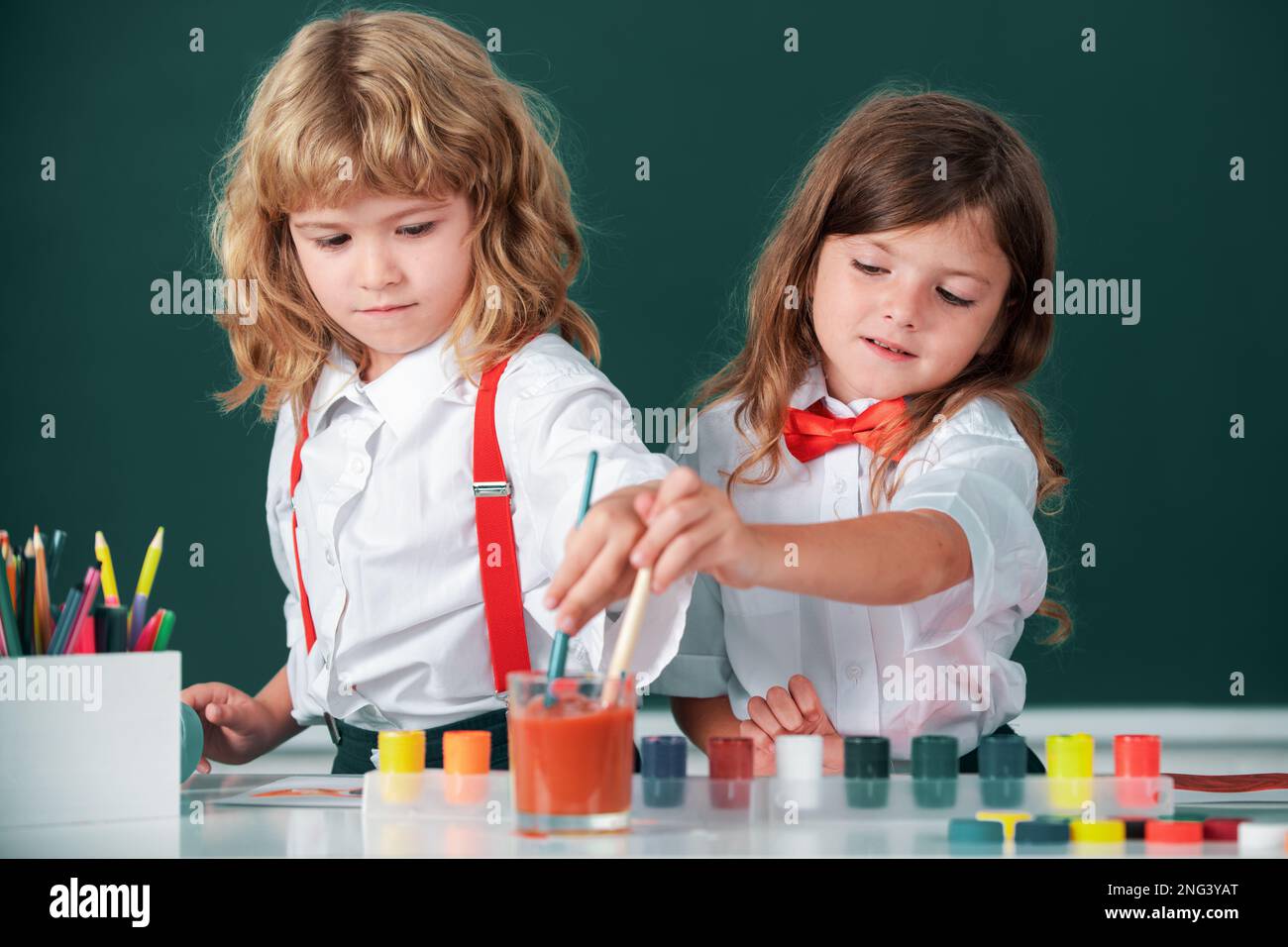 Funny pupils draws in classroom on school blackboard background. School ...