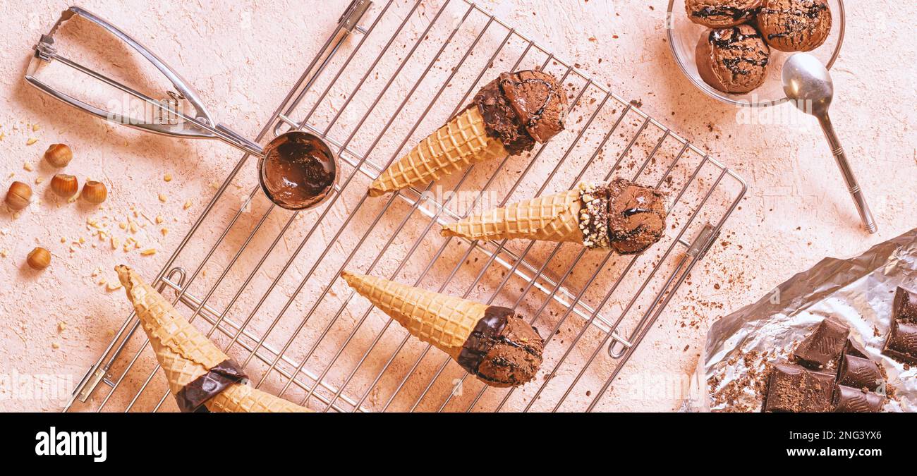 Chocolate ice cream on a metal rack with scoop from stainless steel ...