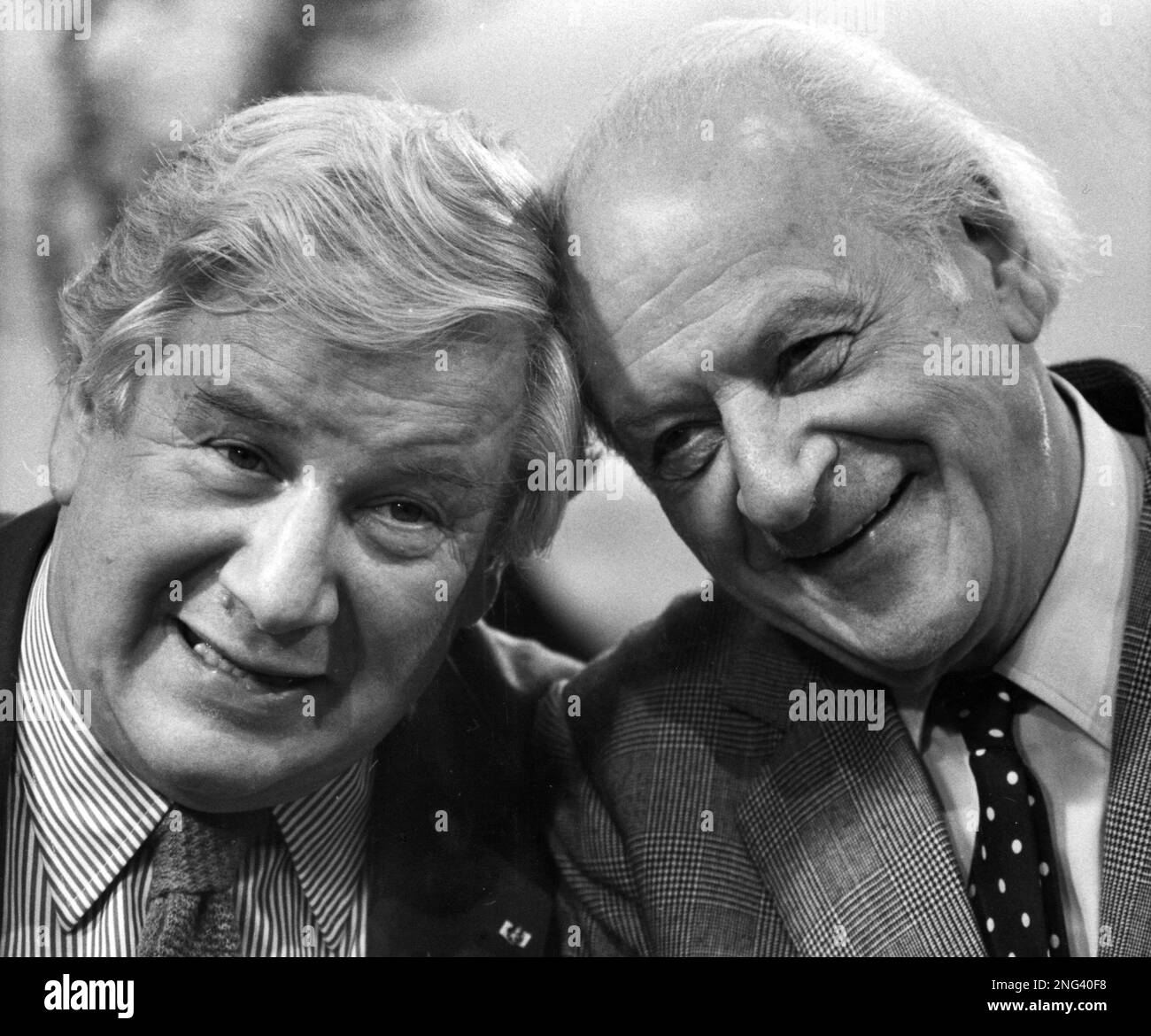 British actor Peter Ustinov, left, leans his head against the head of ...