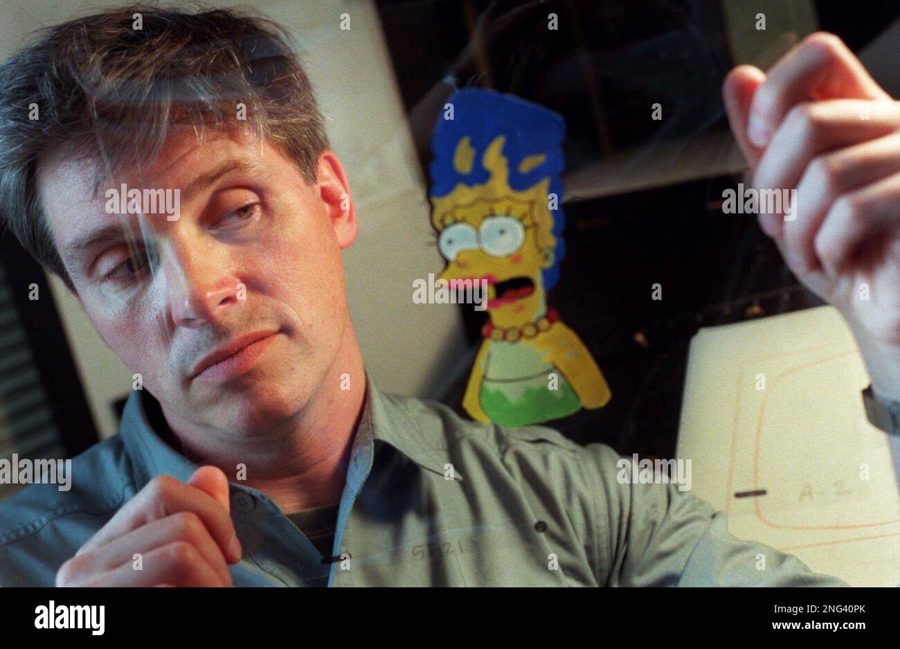 Animation director Mark Kirkland inspects a cell of Marge Simpson from ...