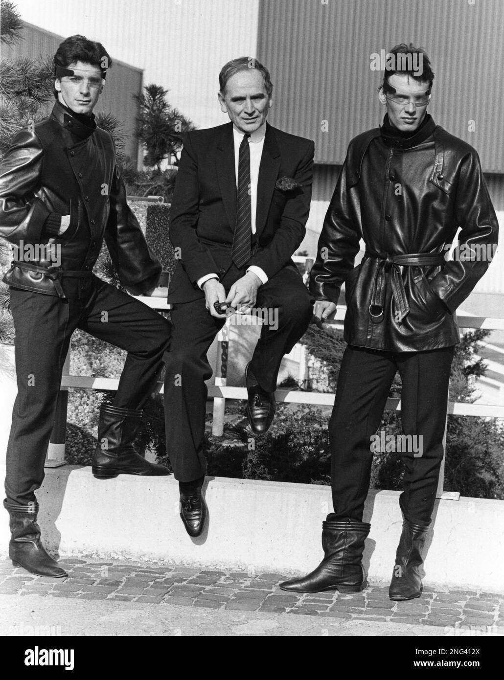 French fashion designer Pierre Cardin flanked by two models with black ...