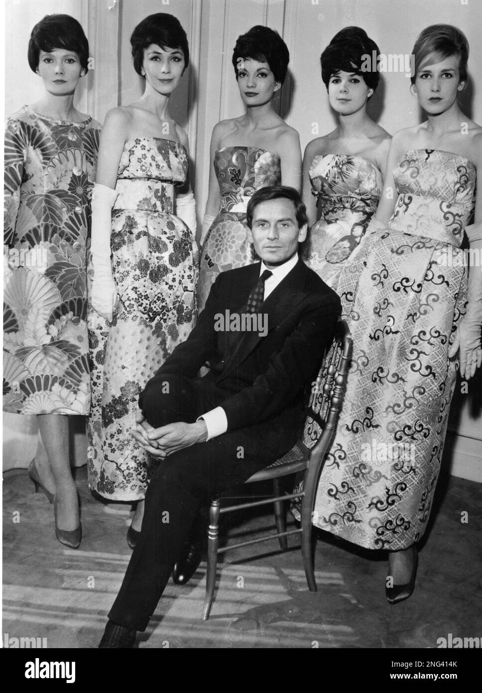 French fashion designer Pierre Cardin sits on a chair sourrounded by ...