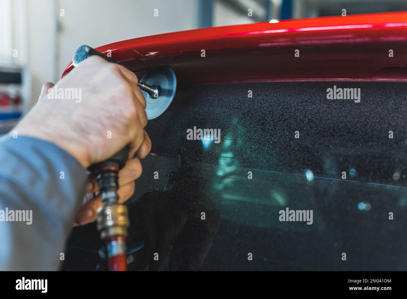 Cutting off the spoiler before replacement - car tuning closeup shot ...