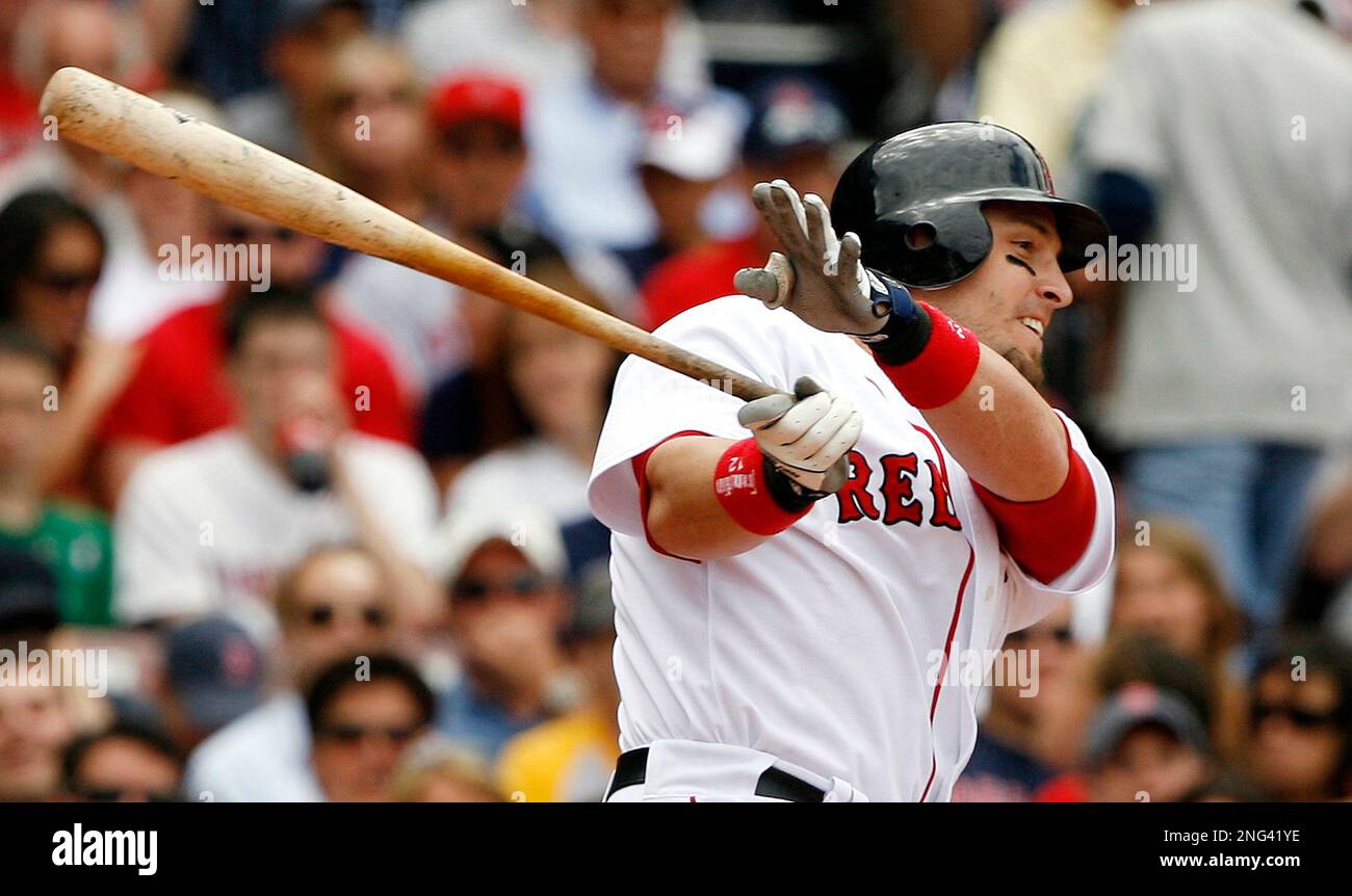 Boston Red Sox' Eric Hinske follows through on a hit in a baseball game ...
