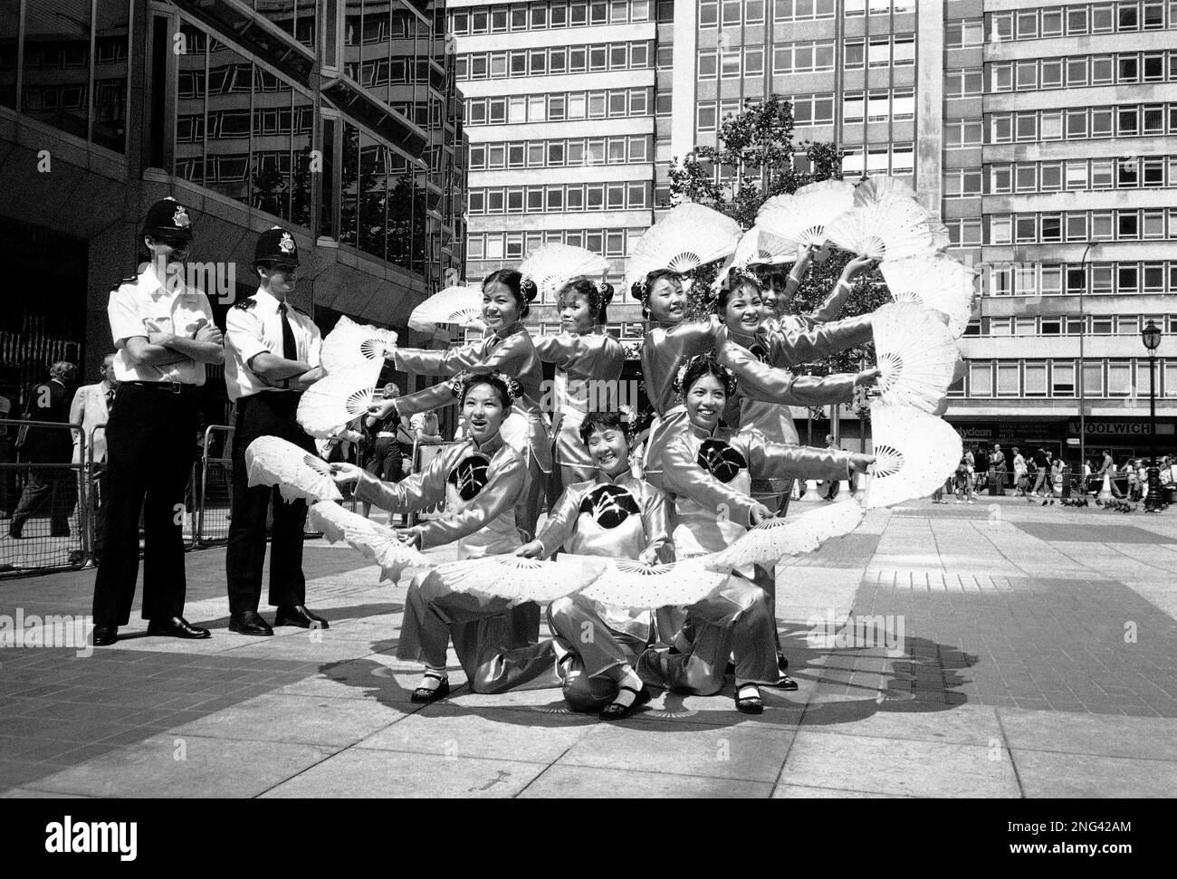 Two London policemen smile as they watch members of the Royal Hong Kong ...