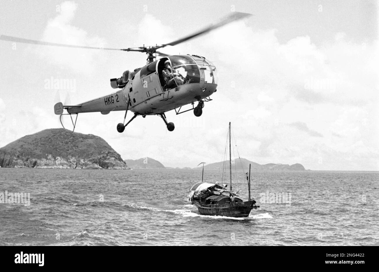Royal Air force helicopter flies over a junk on the high seas during a ...