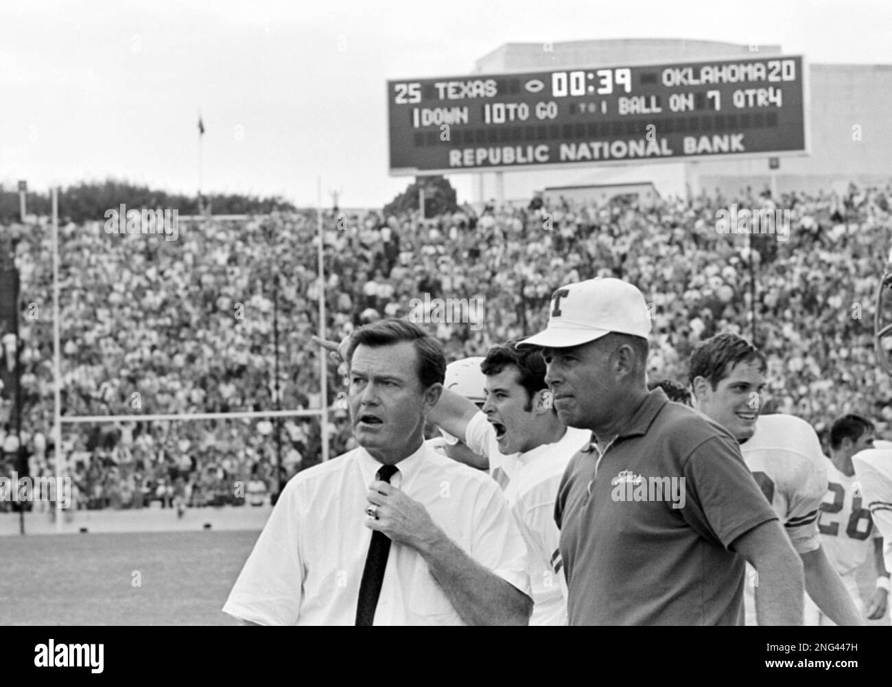 University of Texas head coach Darrell Royal, left, holds back any ...
