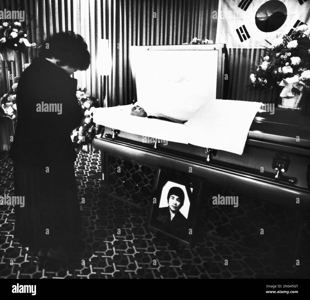 An unidentified mourner pays her respects at the open casket of South ...