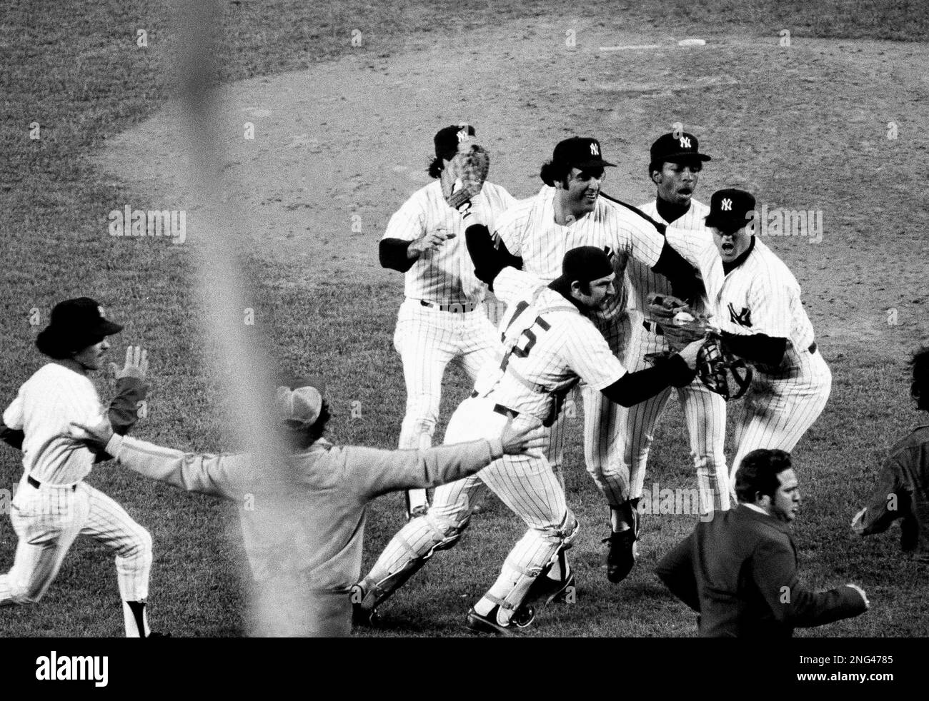 Pitcher Mike Torrez, center, is surrounded by teammates as they head ...