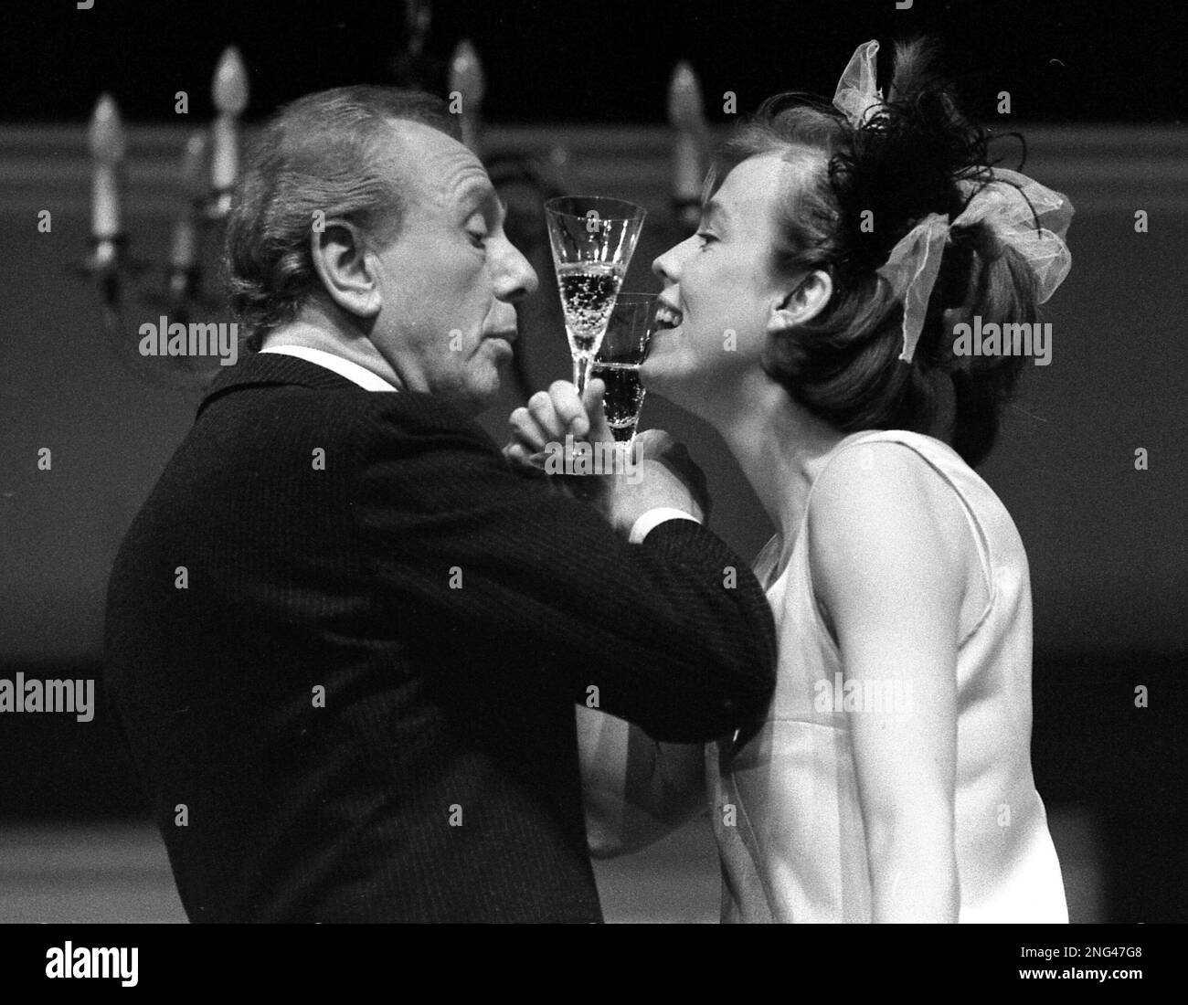 West German actor Horst Keitel shares a glas of Champagne in a scene ...