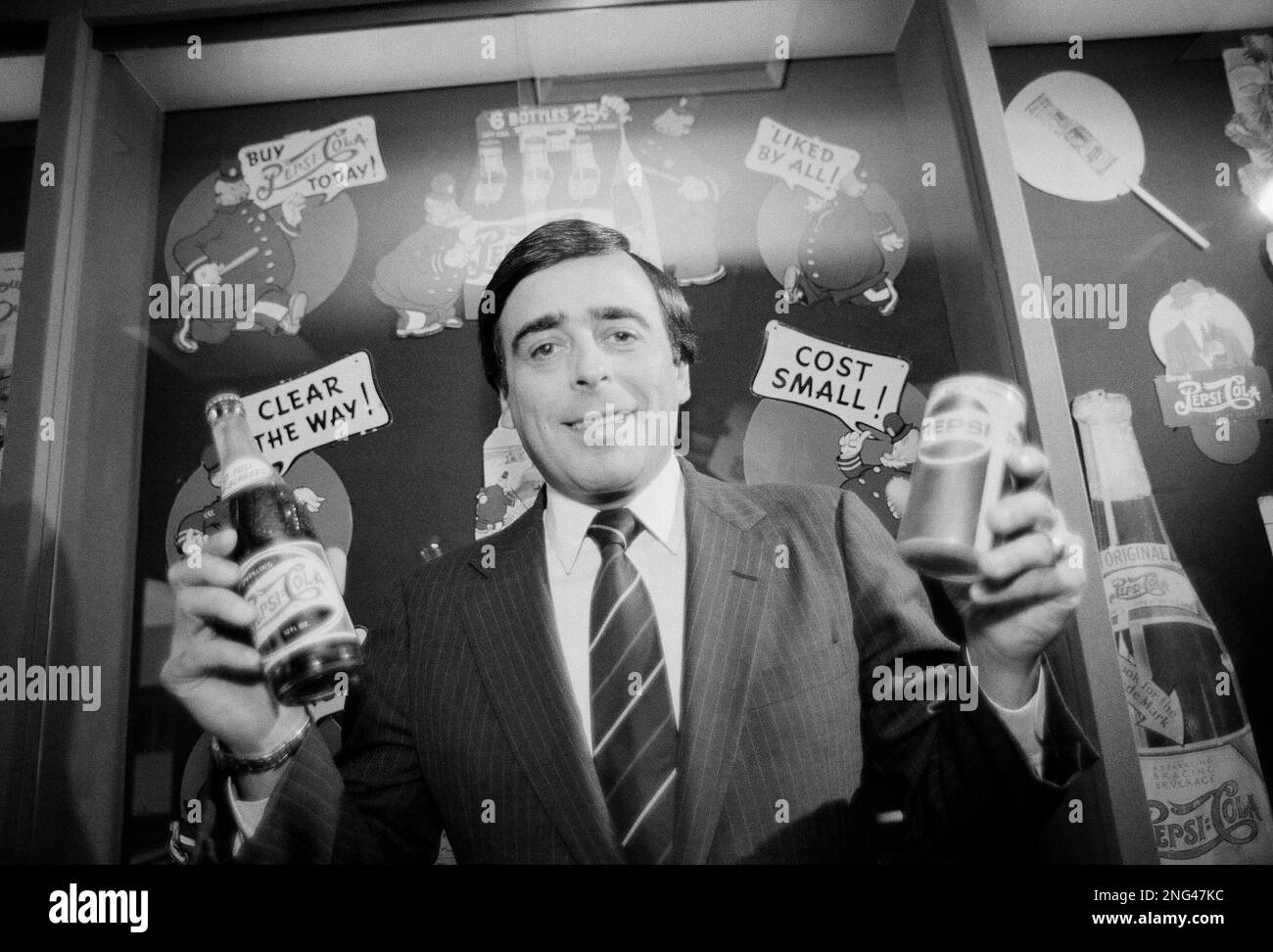 Roger Enrico chairman of Pepsi USA, holds a Pepsi can and an old Pepsi ...