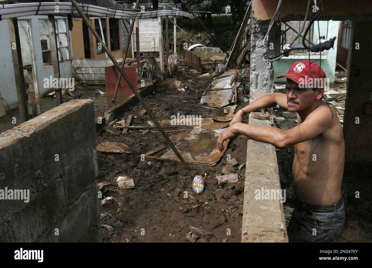 Johnathan Gonzalez looks at the remains of his home destroyed by ...